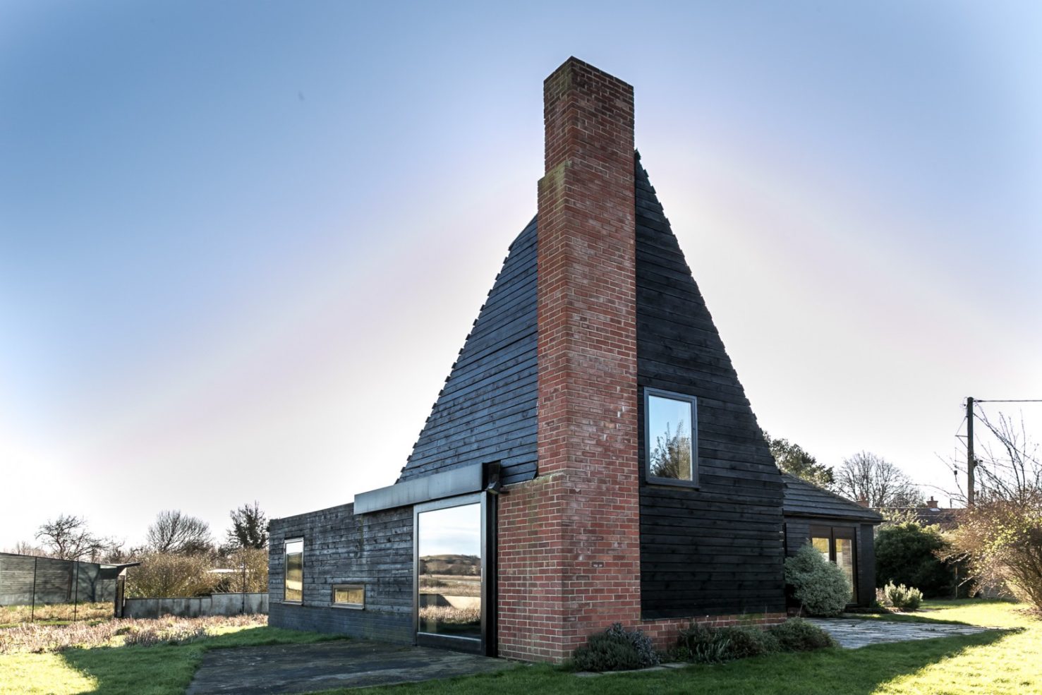 An angular brick and timber house on the Norfolk coast is available for ...